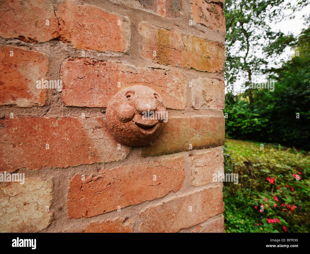 brick face on wall of house smile smiling Stock Photo - Alamy