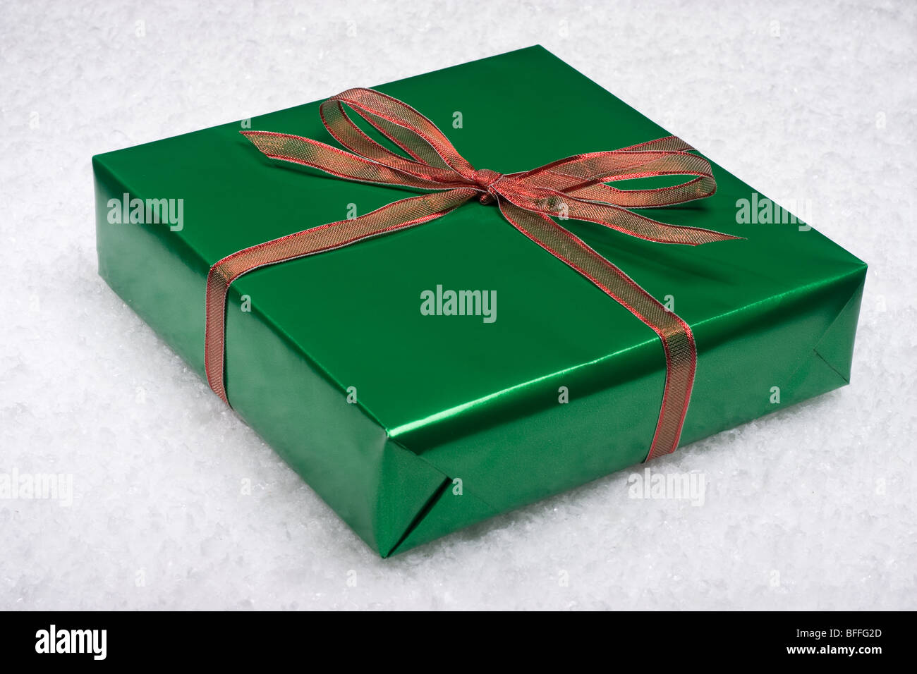 Green Christmas Present on Snow Stock Photo - Alamy