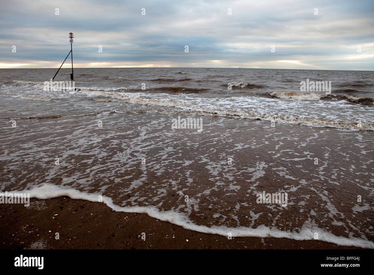 Waves roll onto beach Stock Photo - Alamy