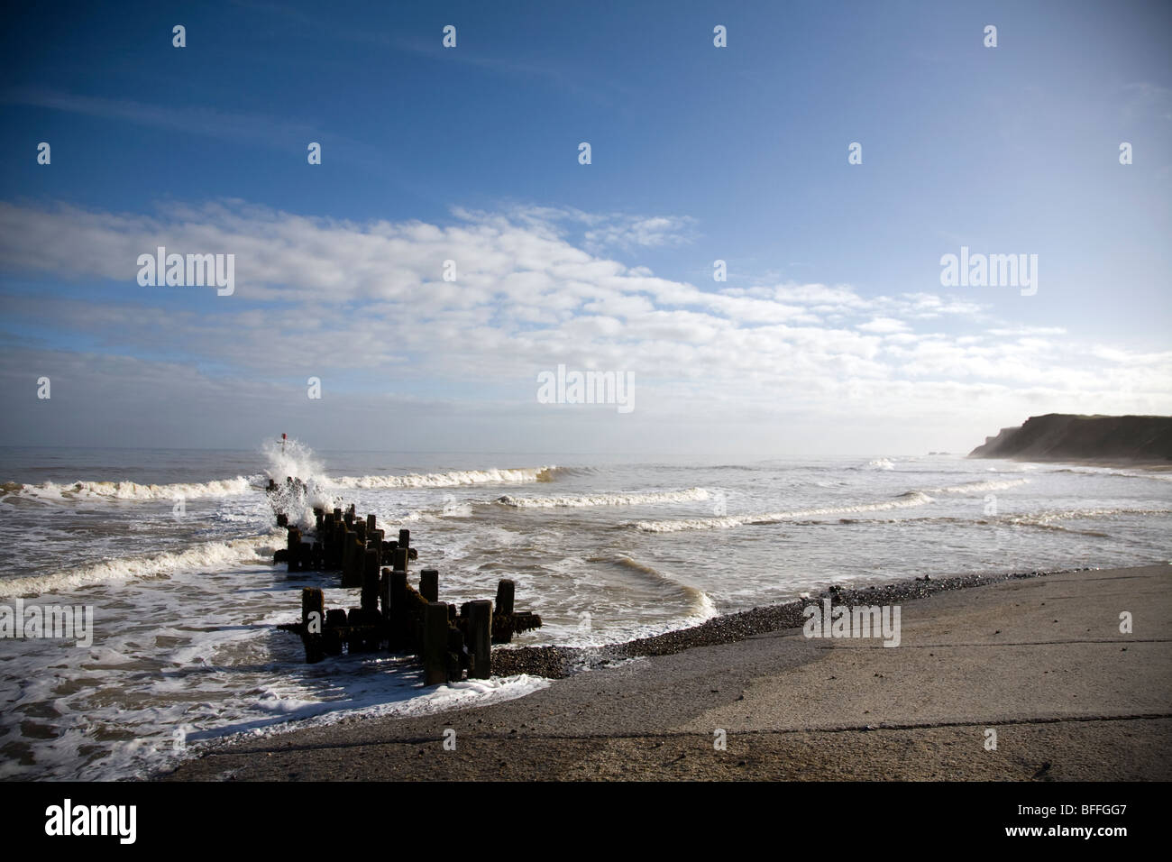 Waves Splash and Distant Cliffs Stock Photo - Alamy