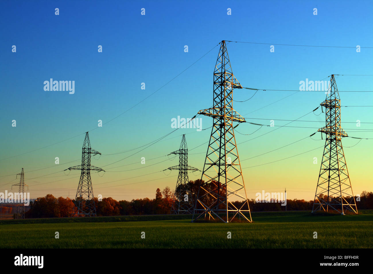 sunset landscape with electricity cable communication towers Stock ...