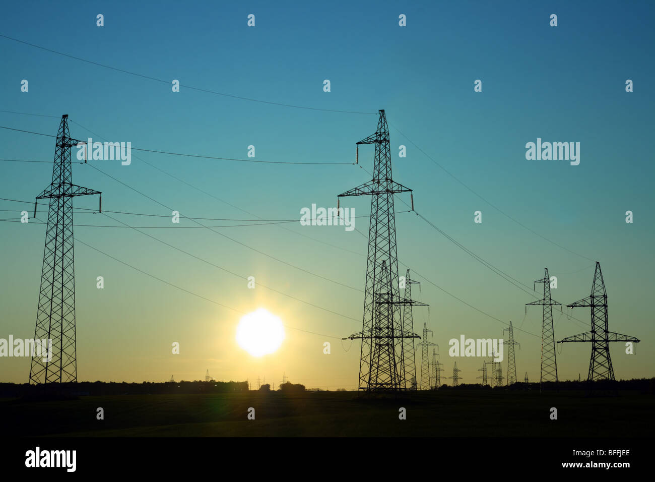sunset landscape with electricity cable communication towers Stock ...