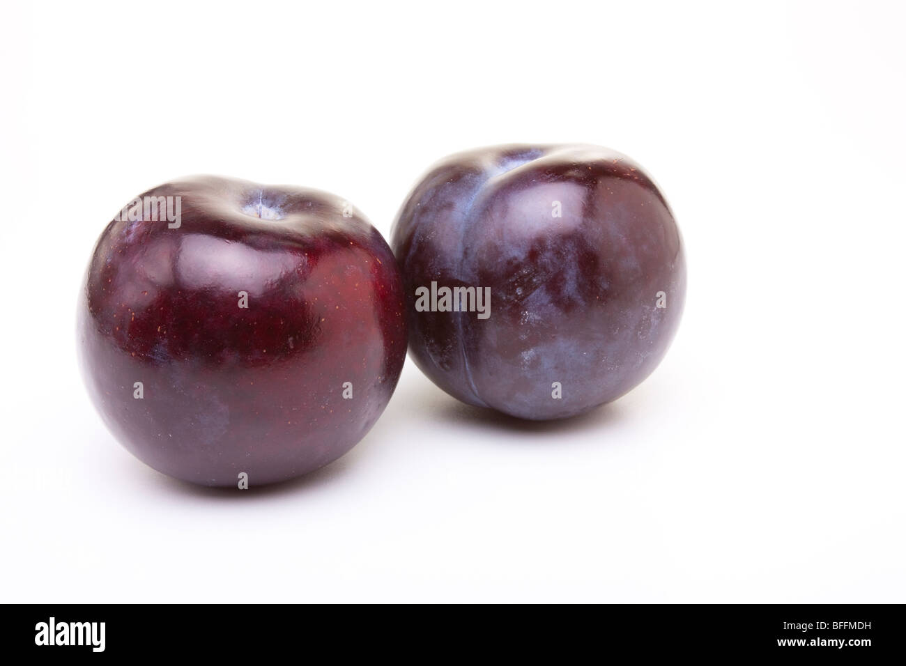 Shiny purple plums isolated against white background Stock Photo - Alamy