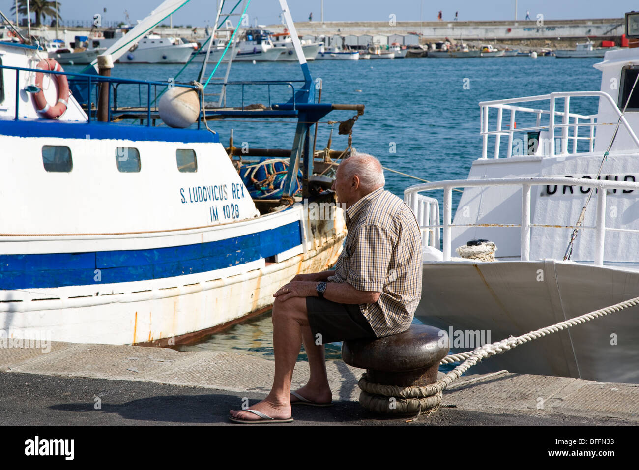 Man watching fishing boats hi-res stock photography and images - Alamy