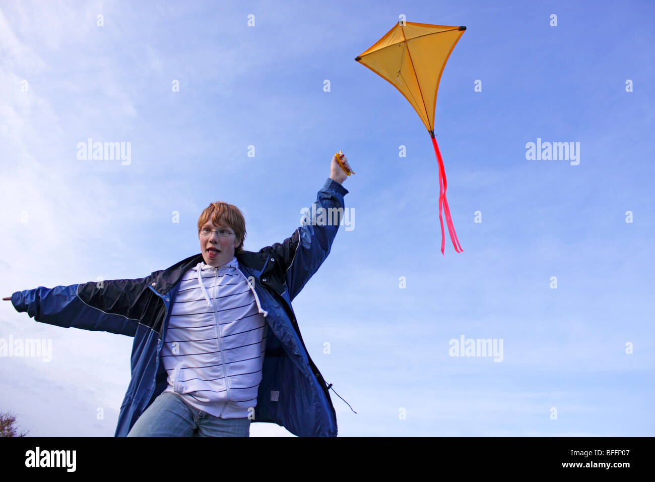 teenage boy flying a kite Stock Photo - Alamy