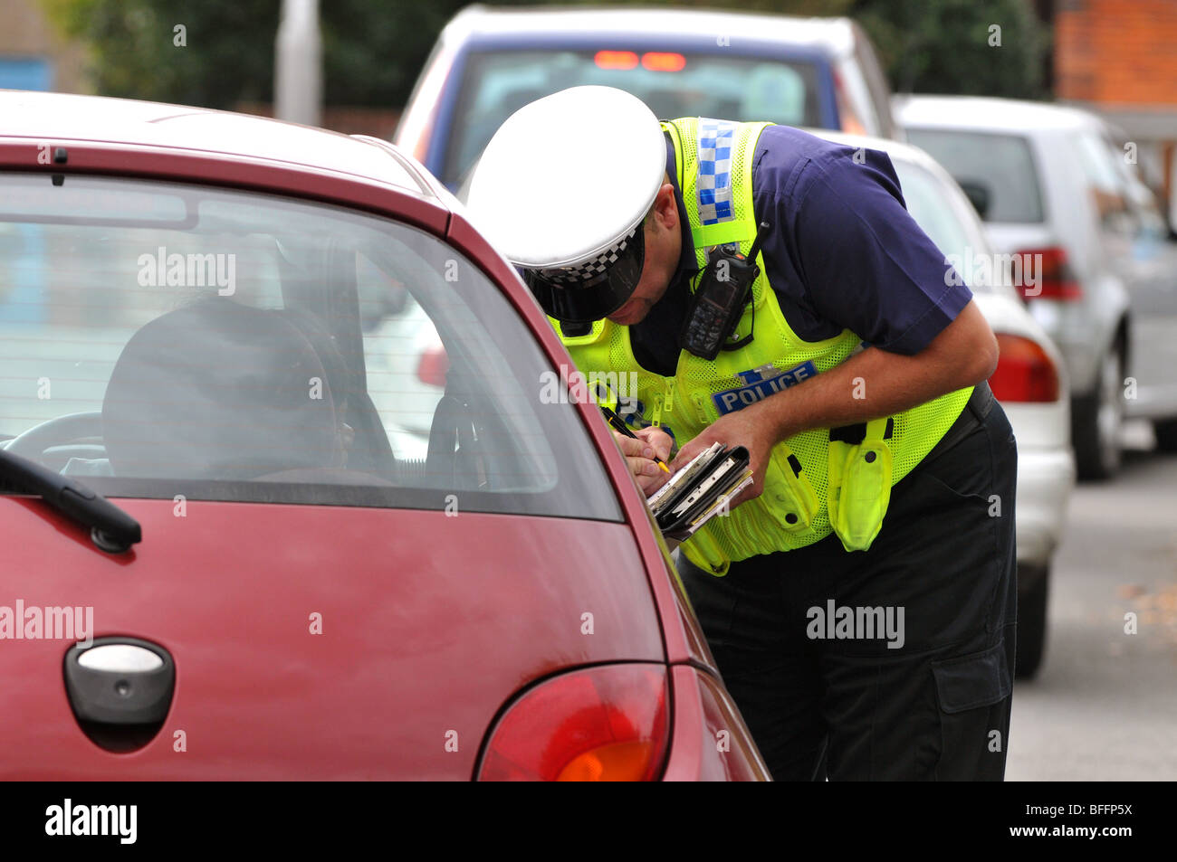 Police Officer issues a ticket to a driver of a car, Britain, UK Stock ...