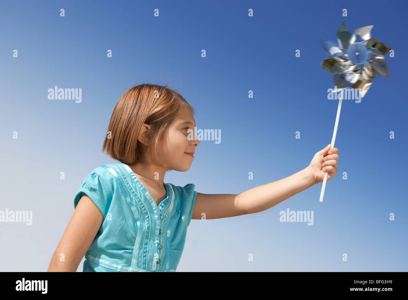 Girl (5-9) with pinwheel, side view, portrait Stock Photo - Alamy