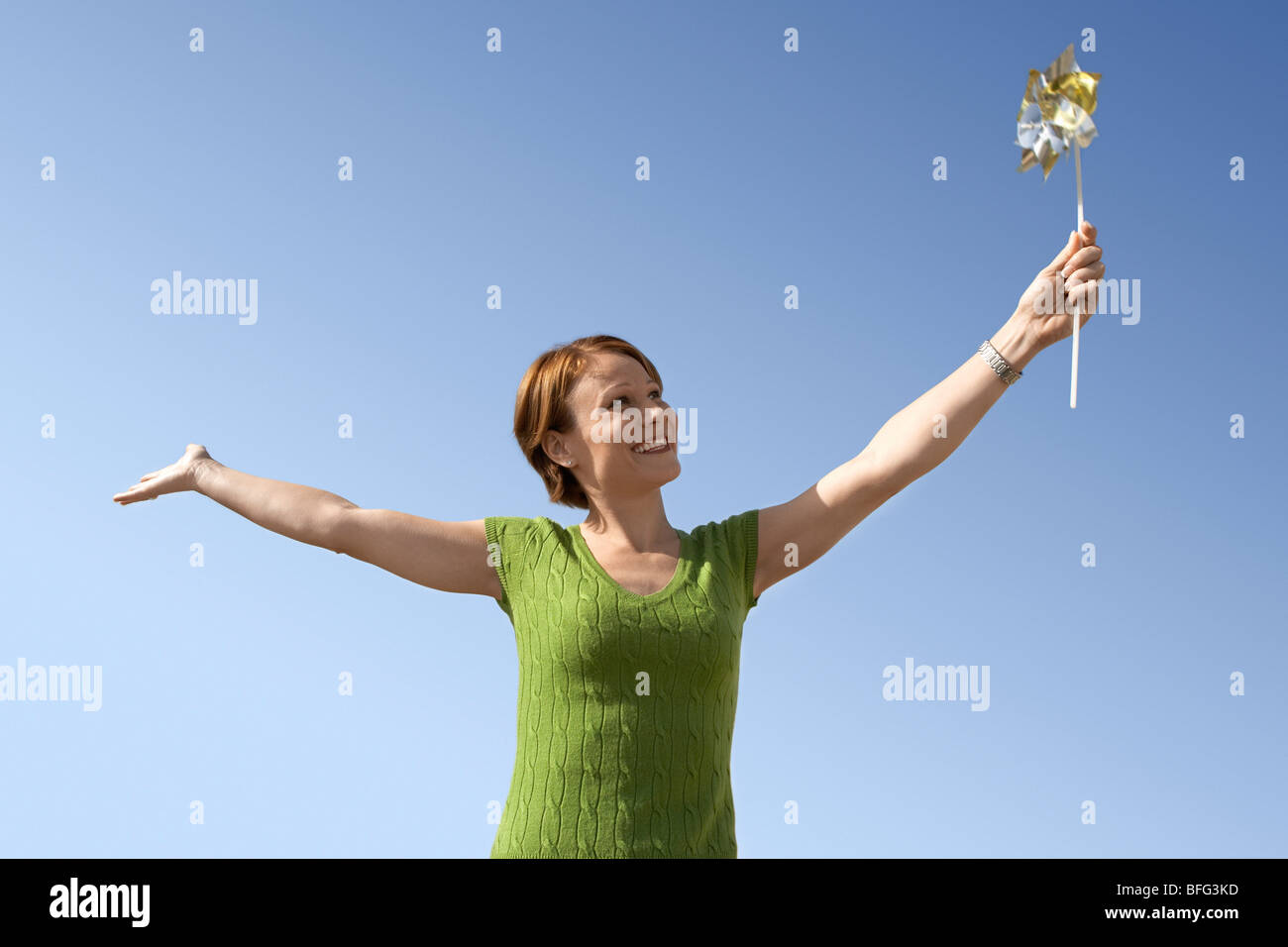 Woman with pinwheel, portrait, low angle view Stock Photo - Alamy