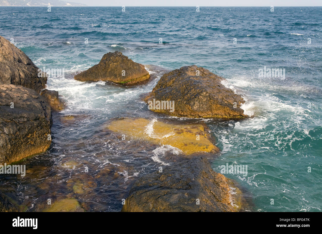 Stony sea coastline and wave with splashes Stock Photo - Alamy