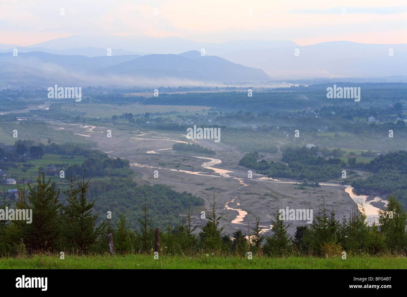 foggy summer countryside evening landscape with mountain behind Stock ...