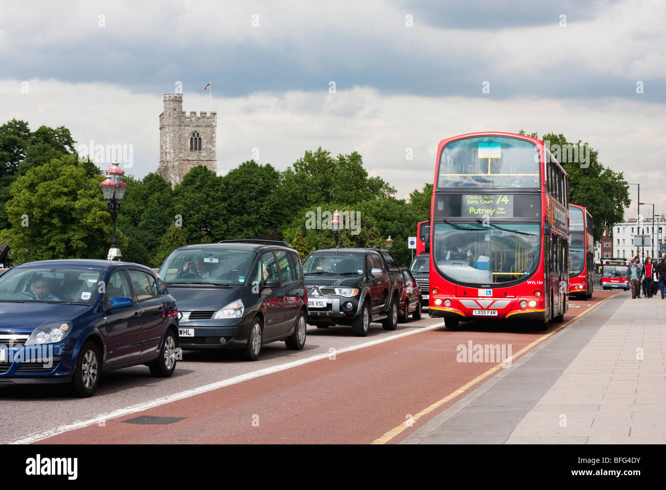 Red bus in bus lane crosses Putney Bridge, South London, England Stock ...