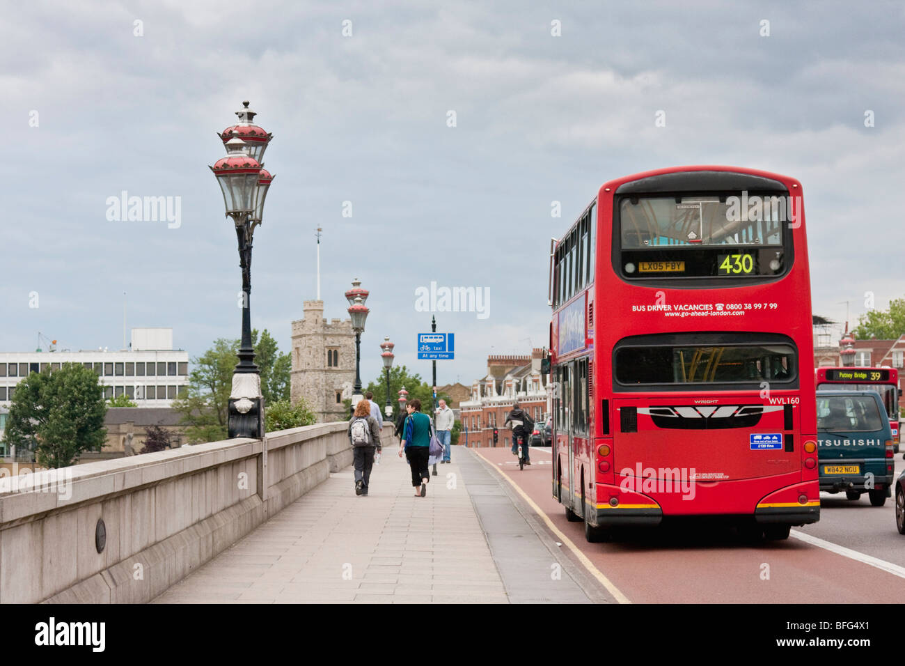 London bus crosses Putney Bridge and Thames River to Putney, South ...
