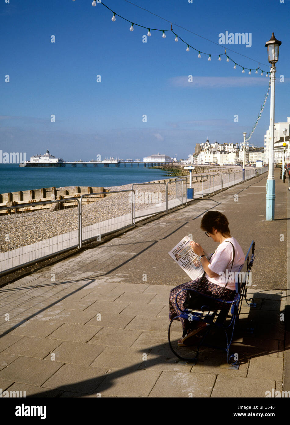 UK, England, Sussex, Eastbourne, visitor reading in sunshine on the ...