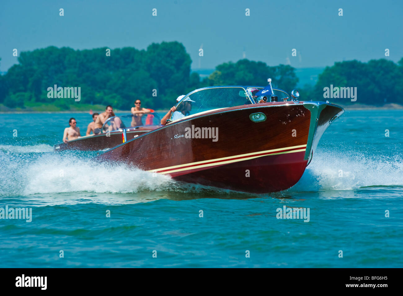 Classic wooden power boat Riva Super Florida with high speed leaving ...