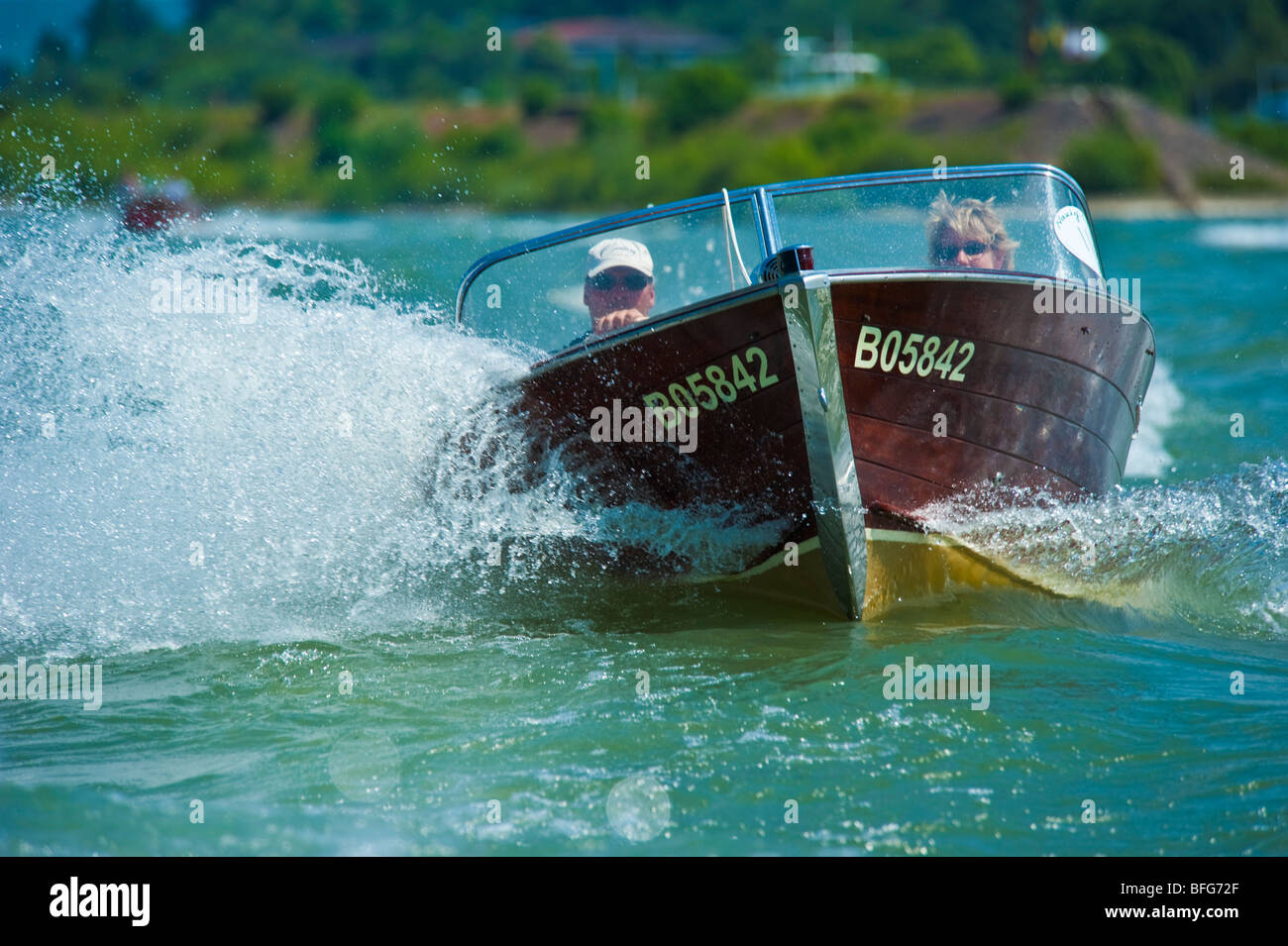 Bow of classical wooden power boat Century Resorter driving with high ...