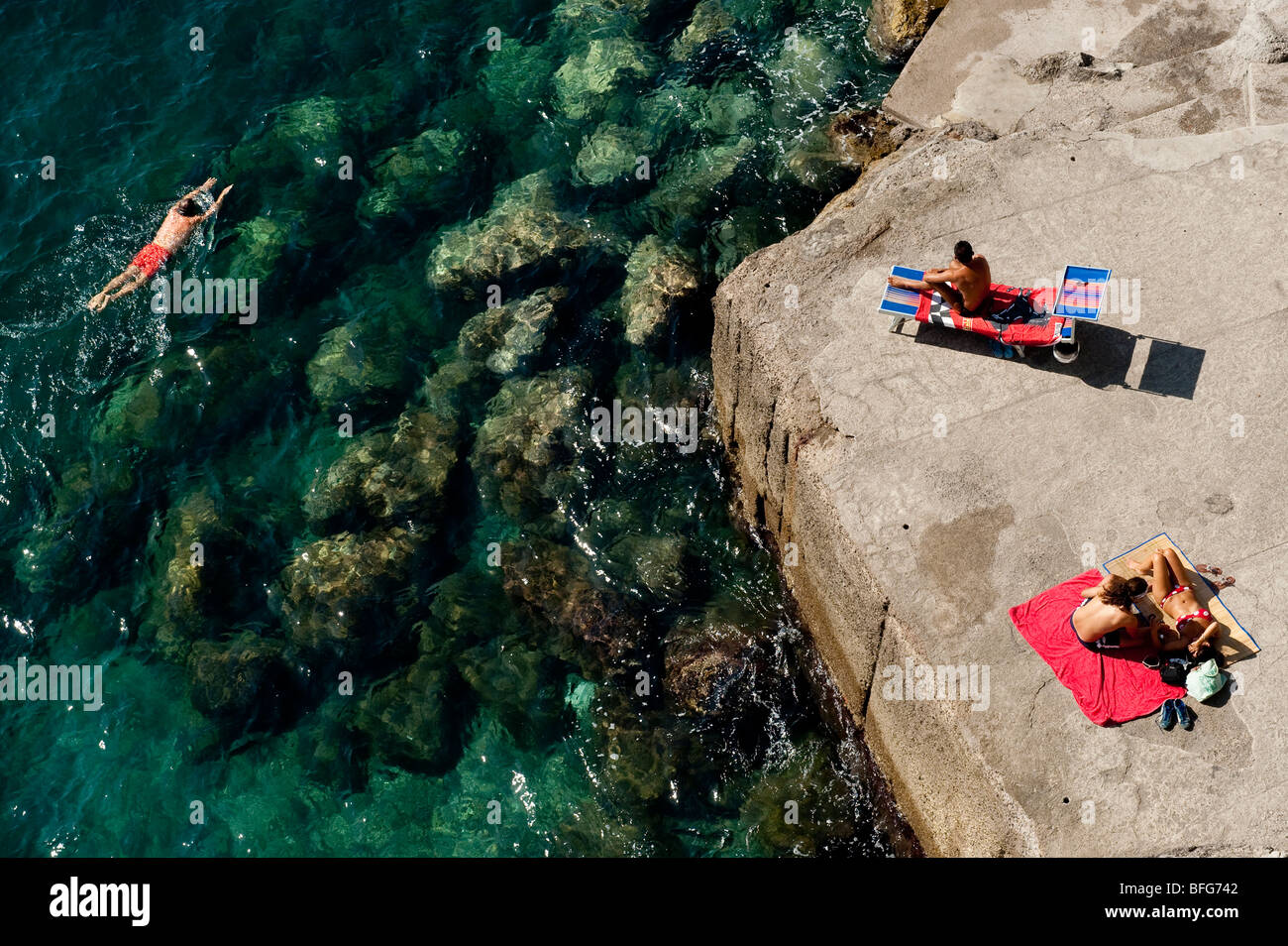 People sun bathing and swimming, Atrani, Amalfi Coast, Italy Stock ...