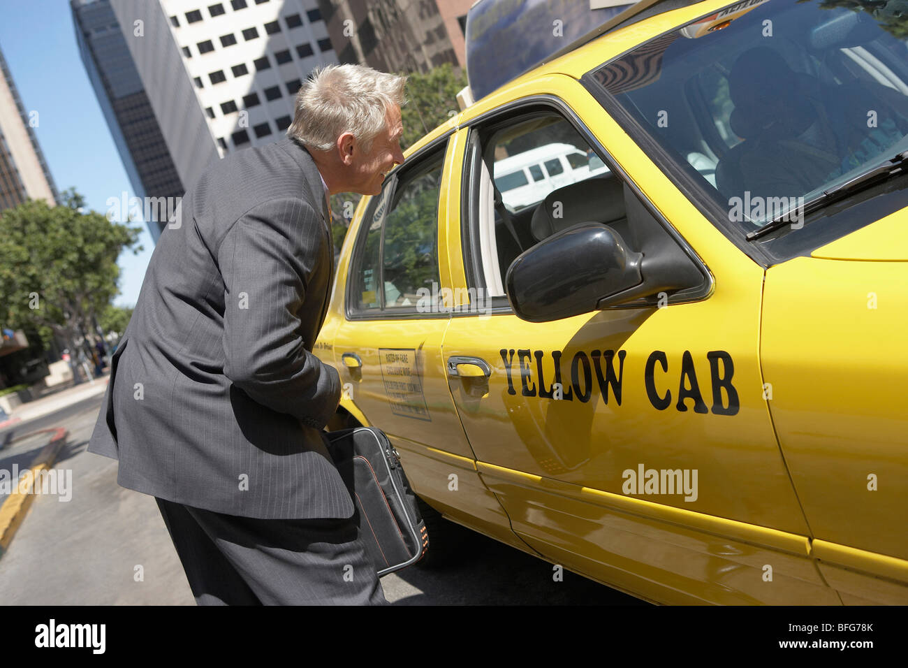 Businessman talking to taxi driver Stock Photo - Alamy
