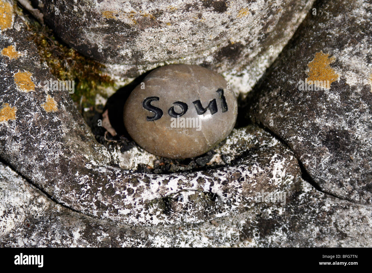 Soul stone sitting in the lap of a stone buddha Stock Photo - Alamy