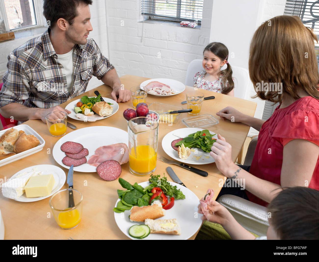 Family with children (3-6) at dining room table Stock Photo - Alamy