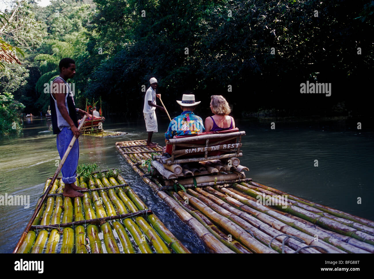 Jamaican man, adult man, tour guide, tourists, couple, bamboo raft ...