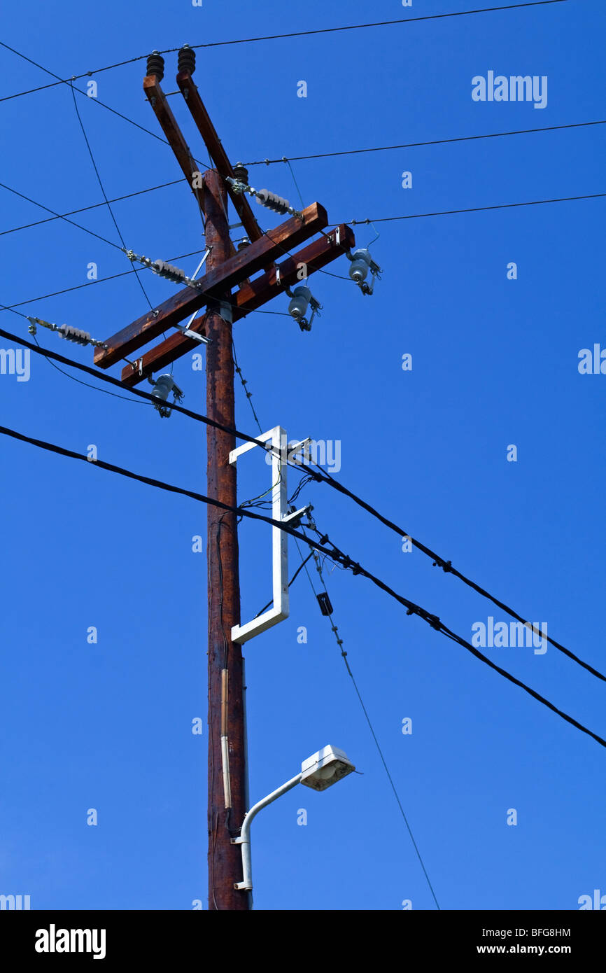 Close up view of telegraph pole with electricity and telephone cables ...