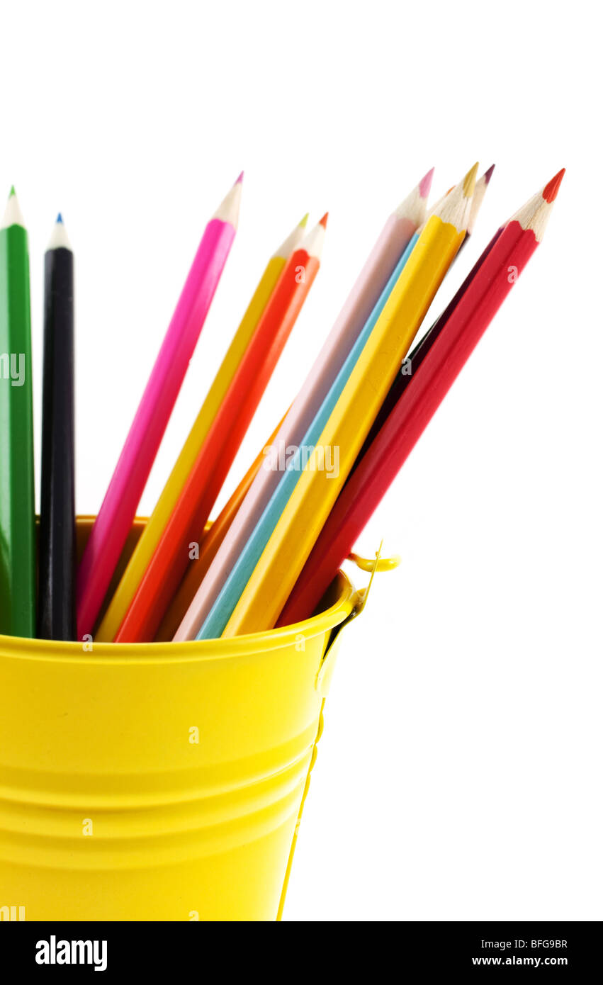 crayons in yellow bucket. White background. small GRIP Stock Photo - Alamy