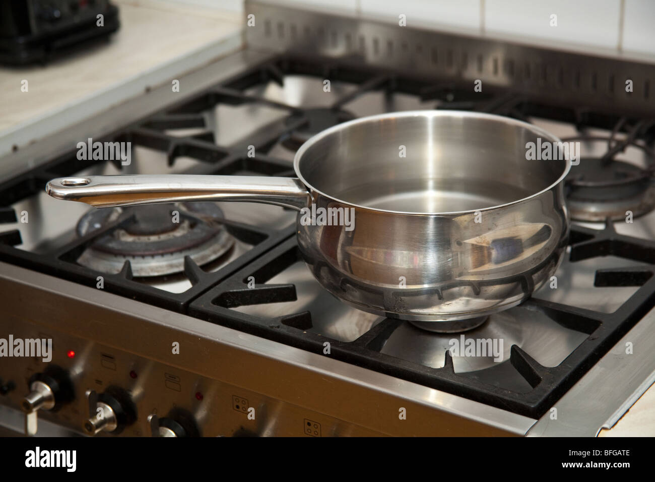 Pan of water boiling on a gas stove Stock Photo - Alamy