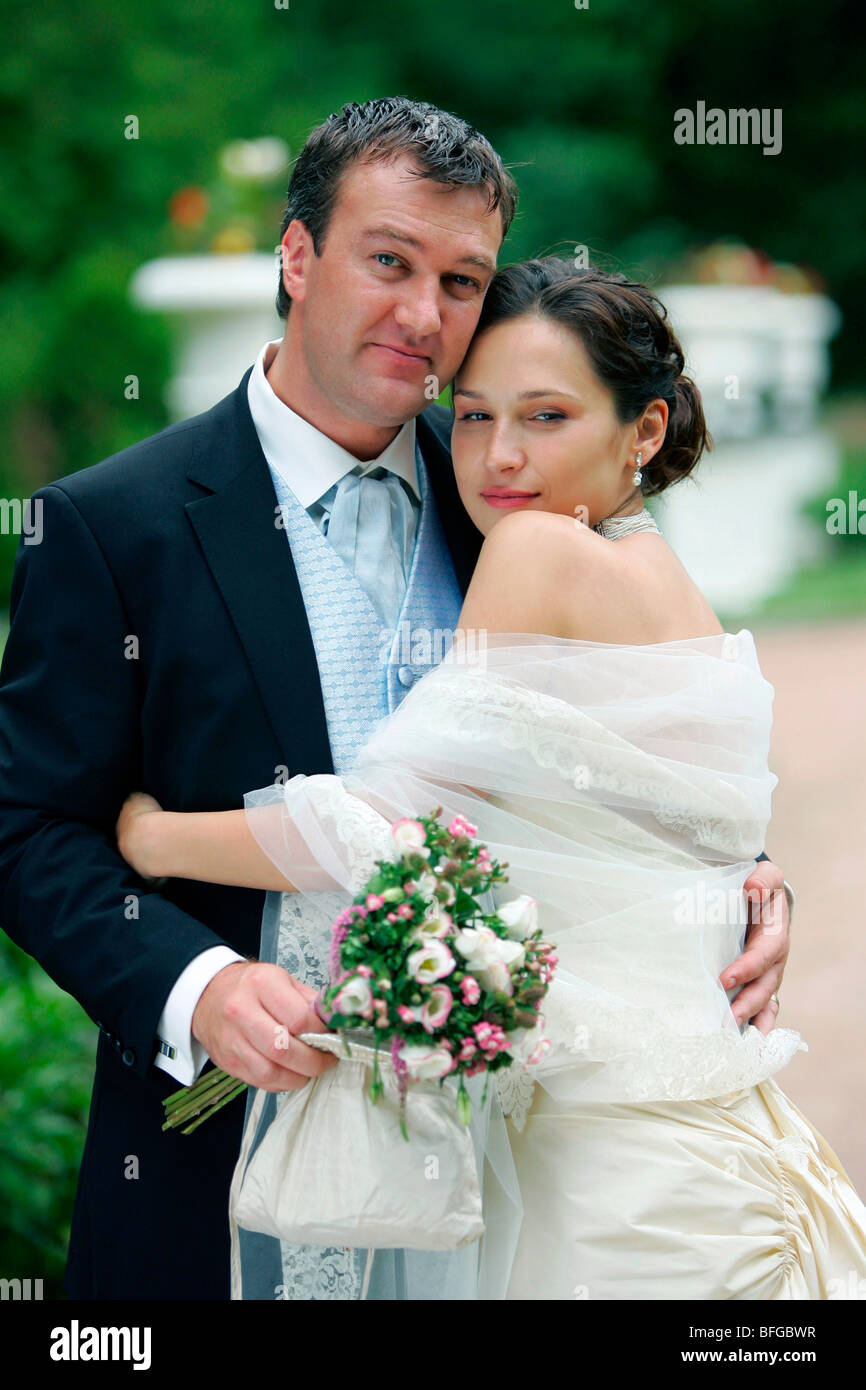 Three quarter body portrait of happy newlywed middle aged couple on ...