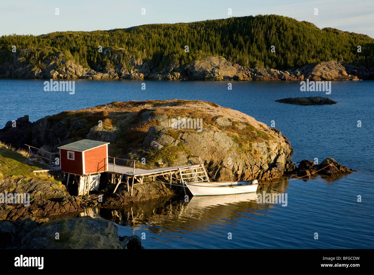 Small boat docked at a stage (or dock) on Change Islands, Newfoundland ...