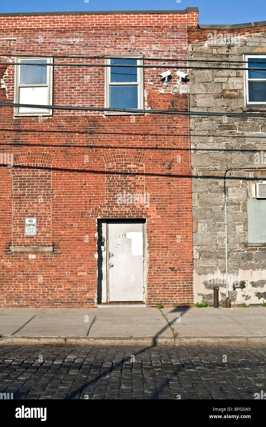 adjoining venerable old brick & stone buildings with clumsy patchwork ...