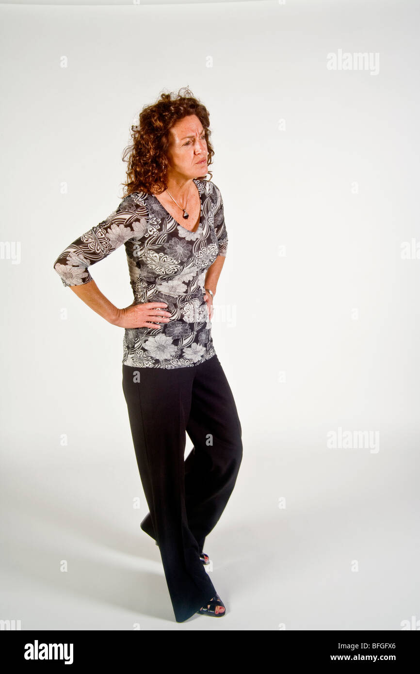 Standing with hands on her hips indicates readiness and aggression via ...