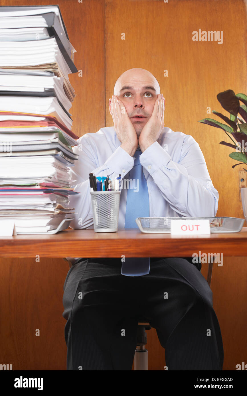 Overworked Businessman at Desk Stock Photo - Alamy