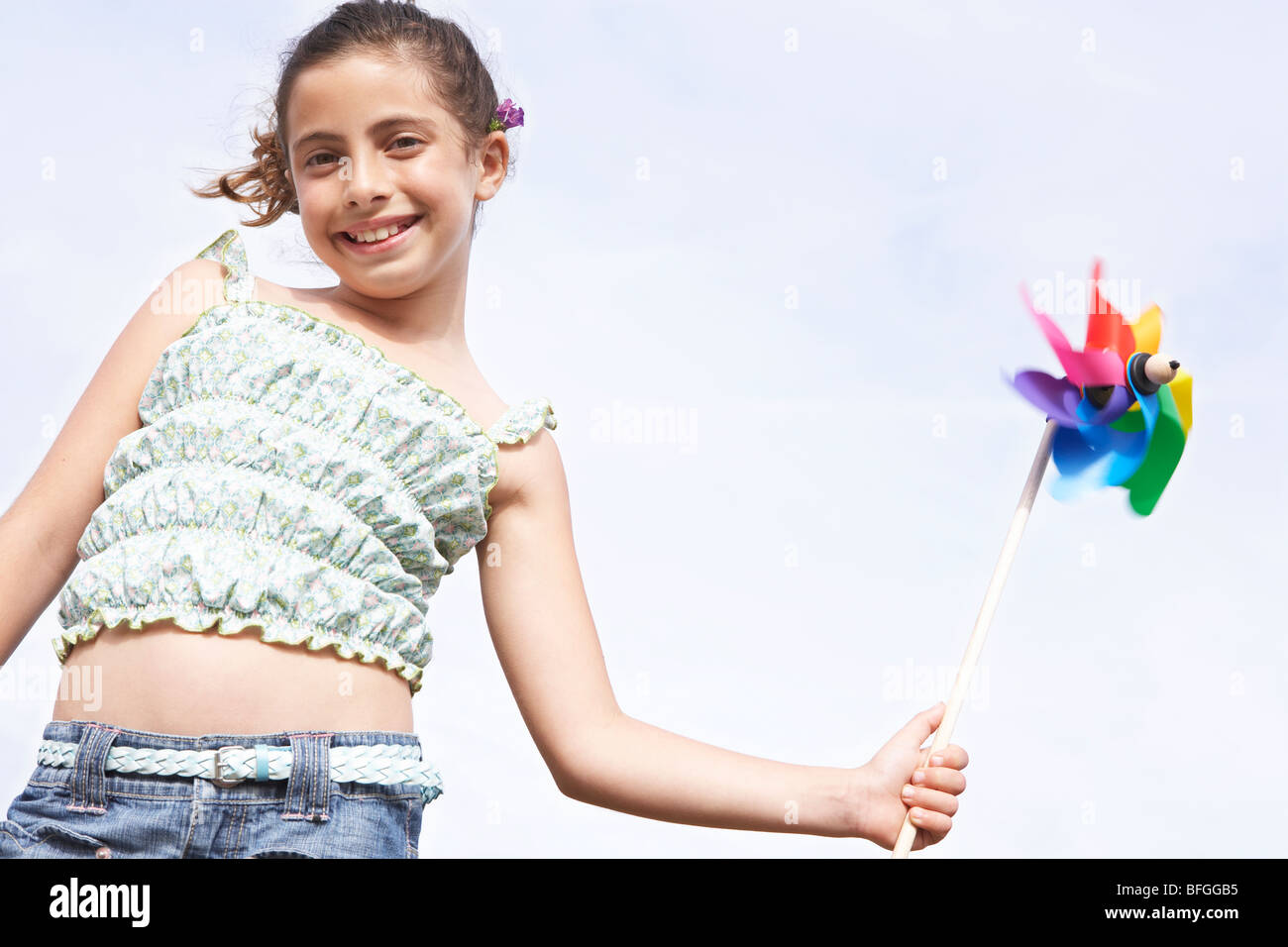 Girl Playing With Pinwheel Stock Photo - Alamy
