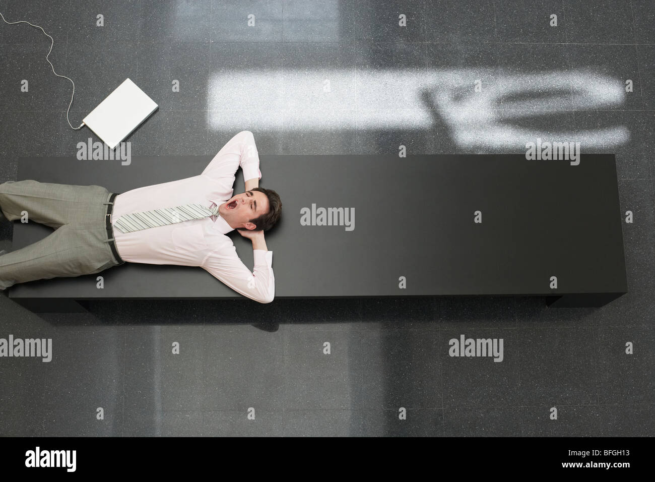 Tired Businessman Lying Down on Desk Stock Photo - Alamy