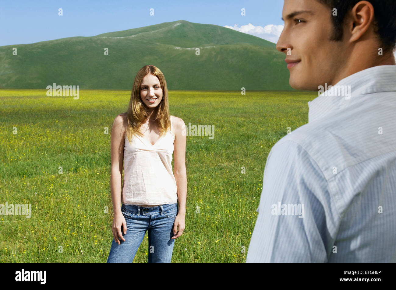 Couple in mountain Meadow, woman looking at man Stock Photo - Alamy