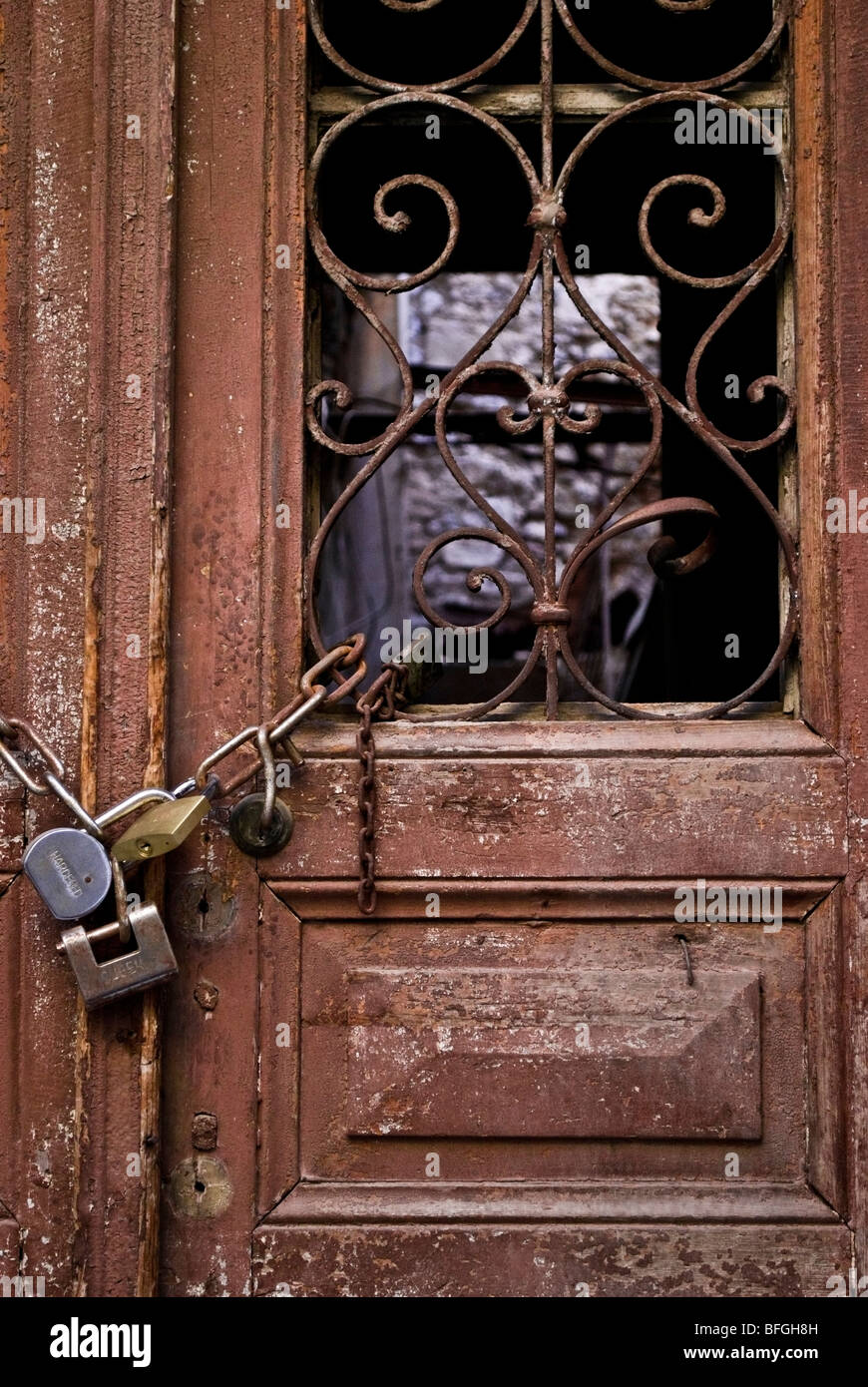A locked-up and rusted metal door from an old house in Plaka Stock ...