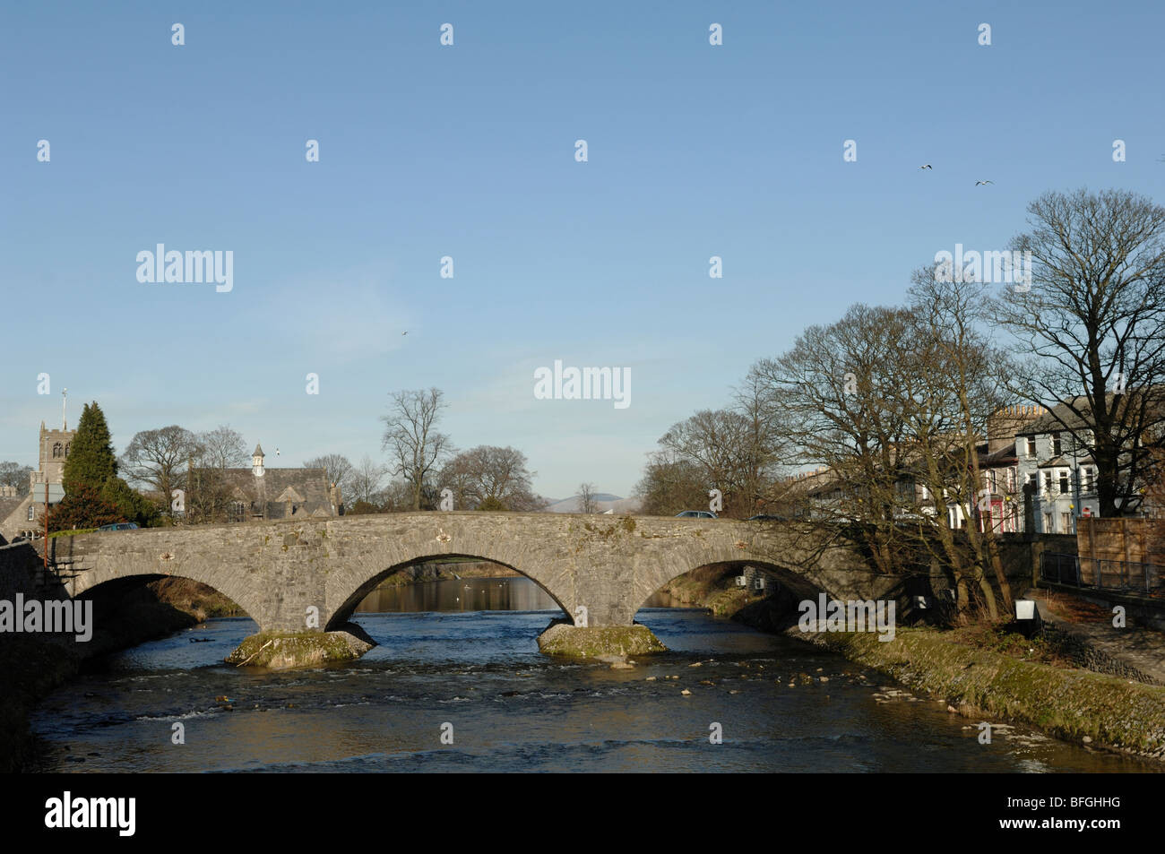 An old stone bridge crossing the River Kent in Kendal Cumbria in North ...