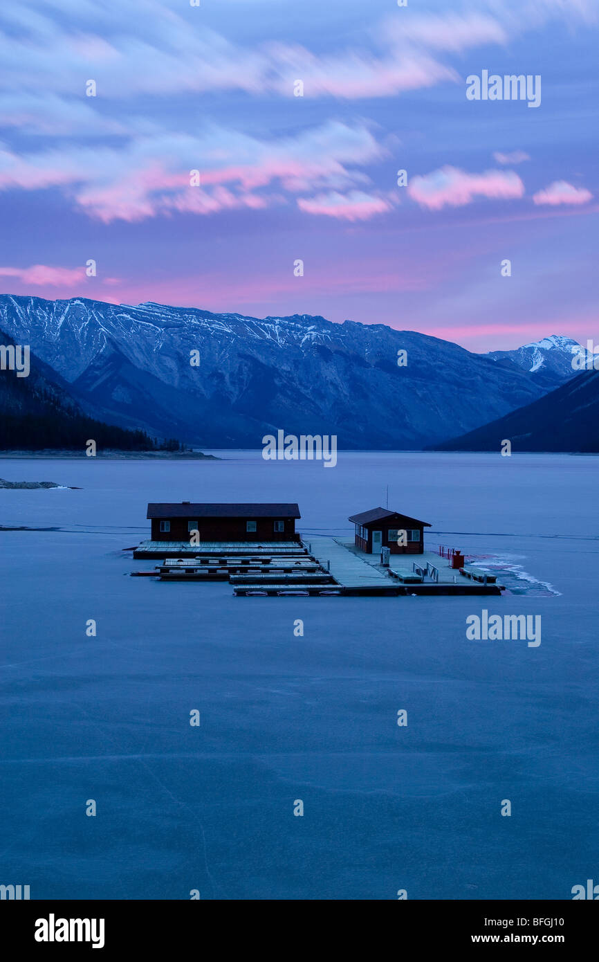 Floating dock on frozen Lake Minnewanka at sunrise, Banff National Park ...