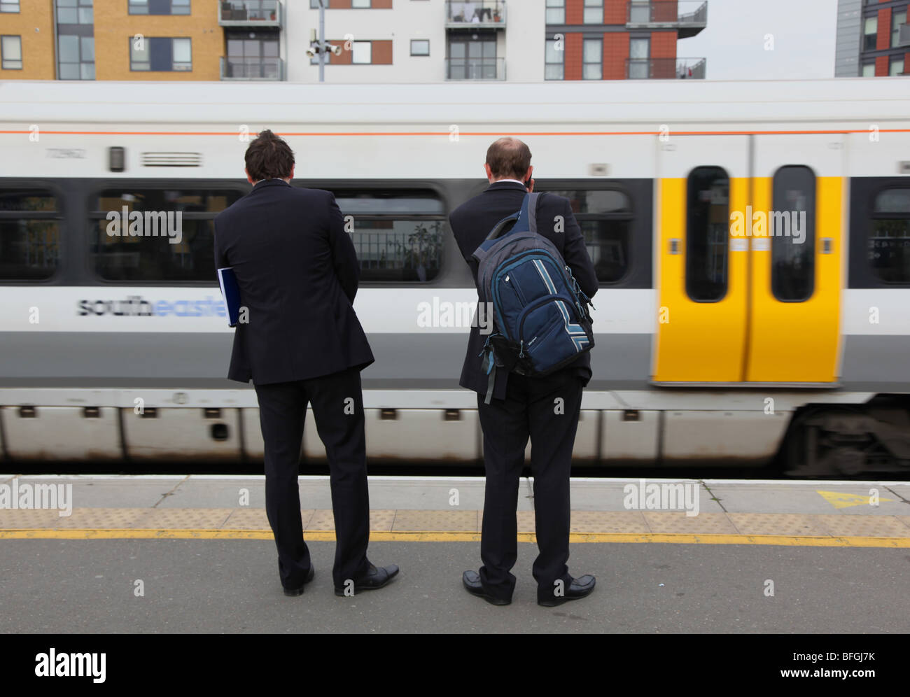 2 men waiting for train Stock Photo - Alamy
