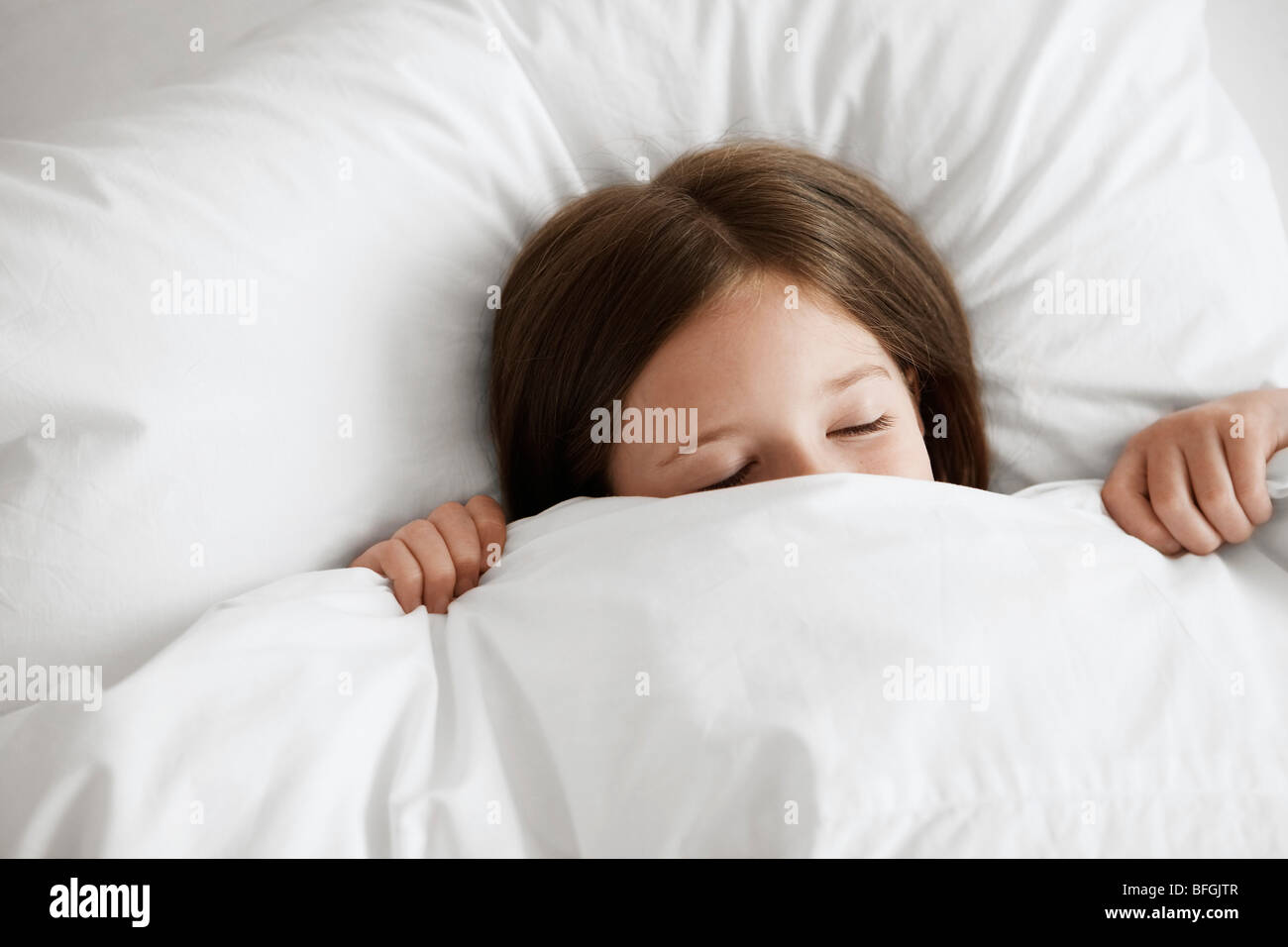 Little girl in bed with covers pulled up over face, , close up, high ...