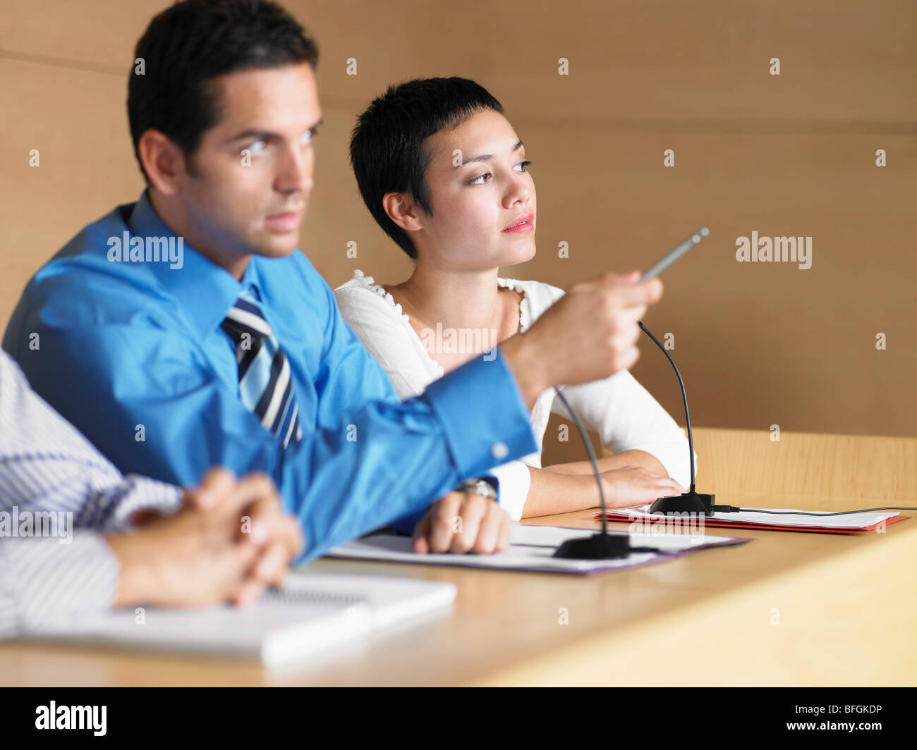 Three businesspeople at Panel Presentation Stock Photo - Alamy