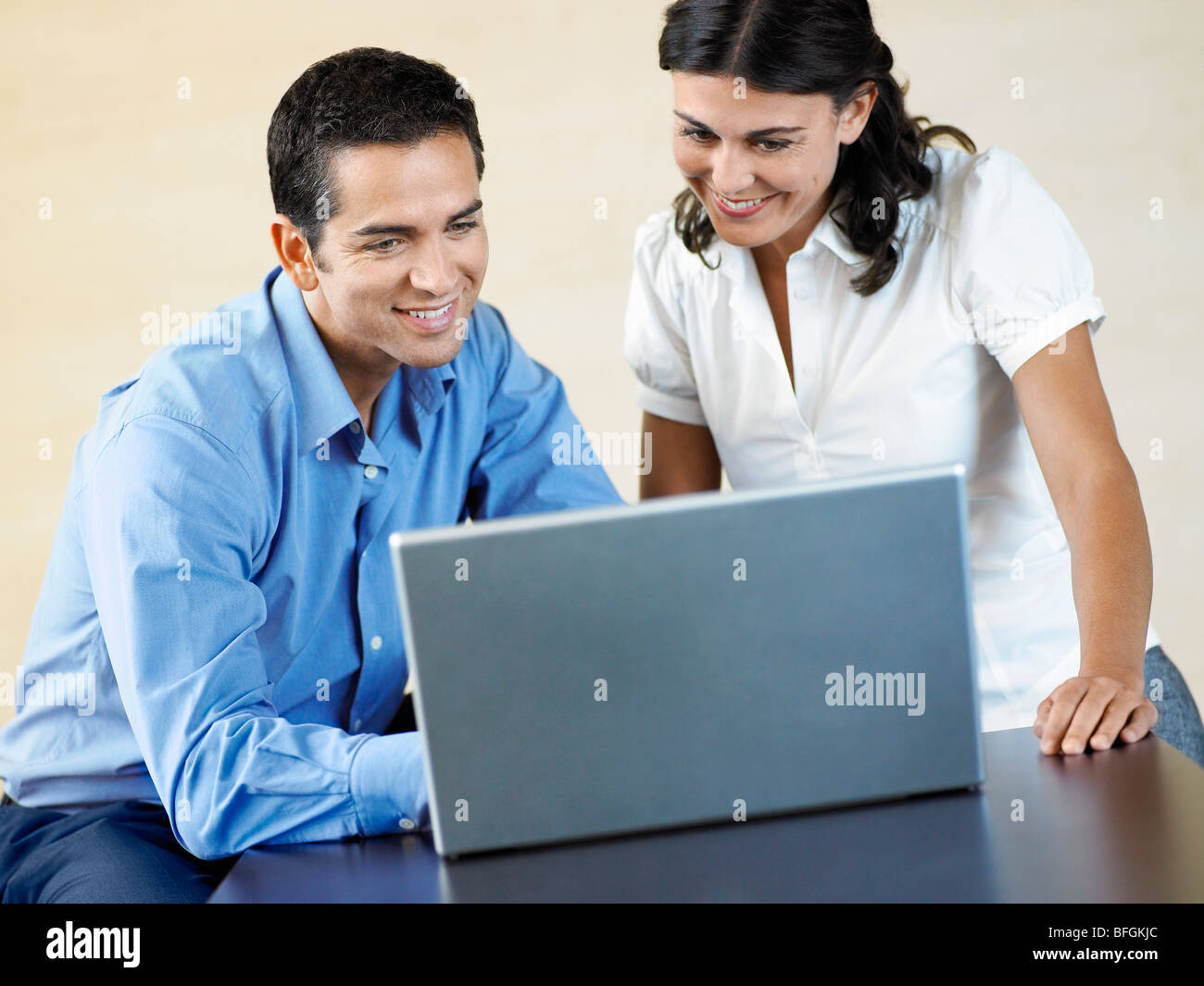 Office Workers Using Laptop Together Stock Photo - Alamy