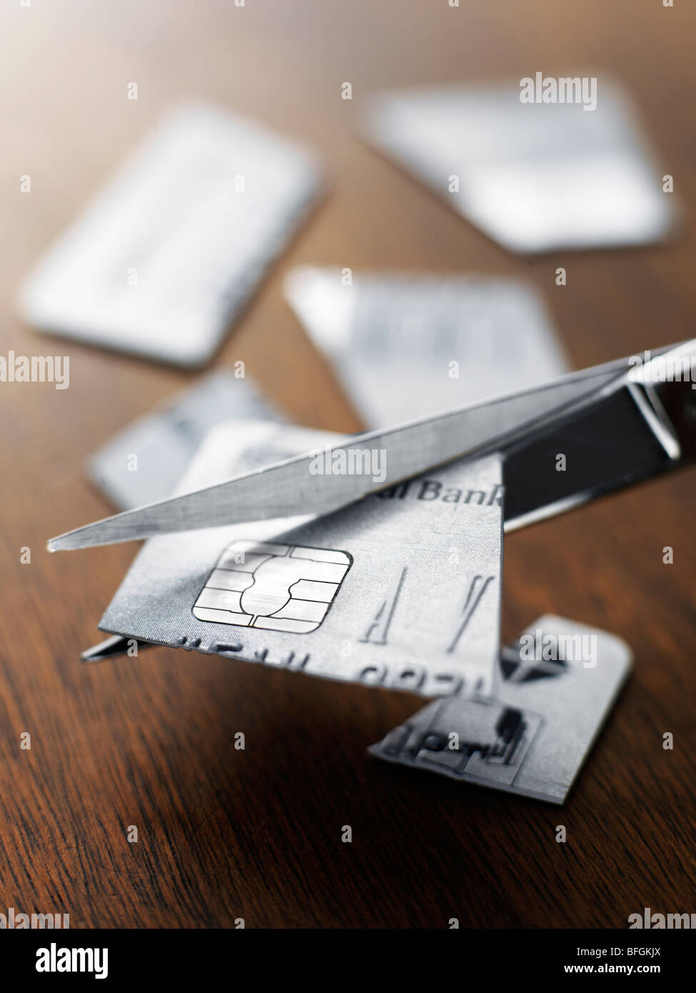 Credit card being cut up with scissors Stock Photo - Alamy
