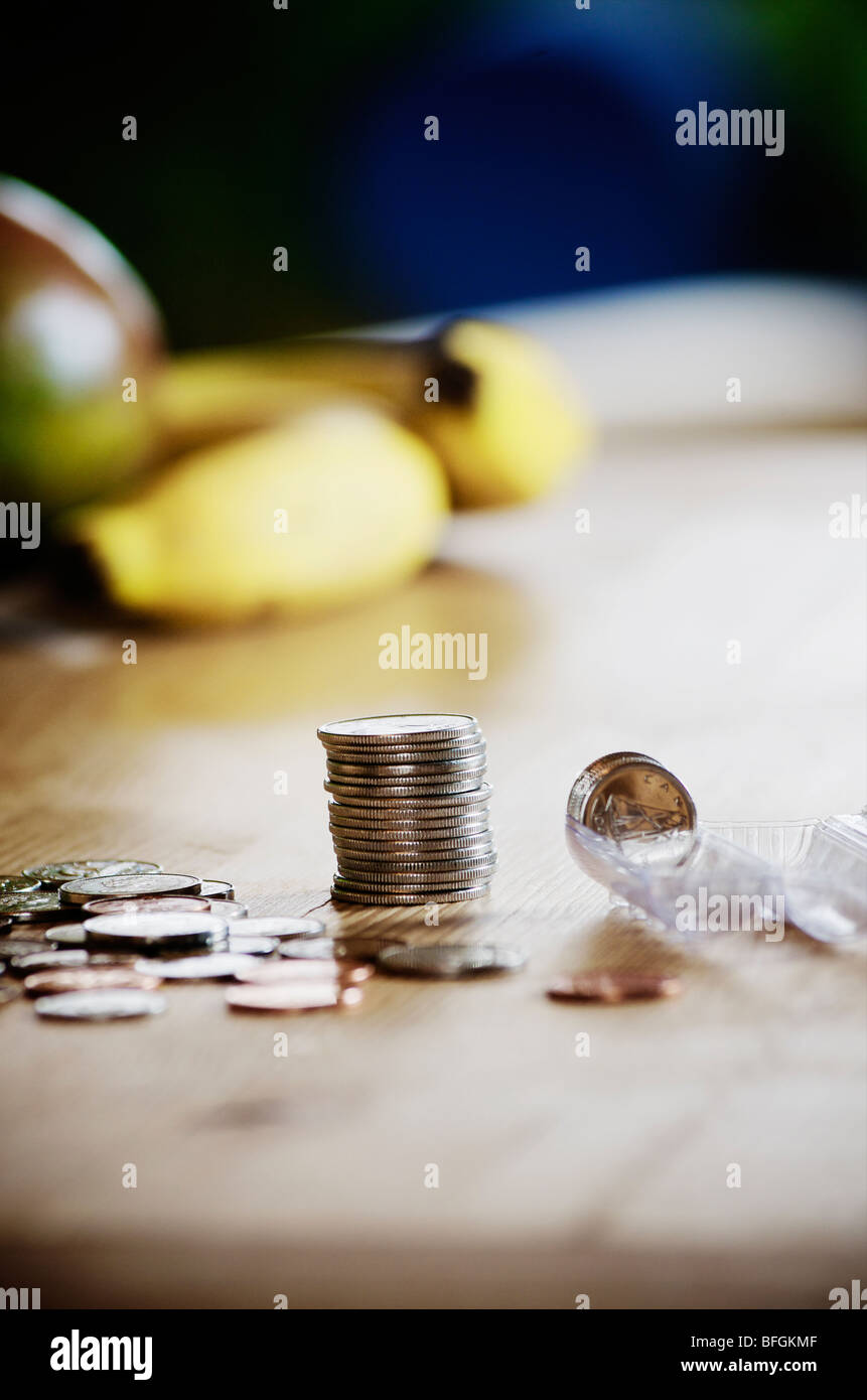 Coins being rolled on a dinning room table Stock Photo - Alamy