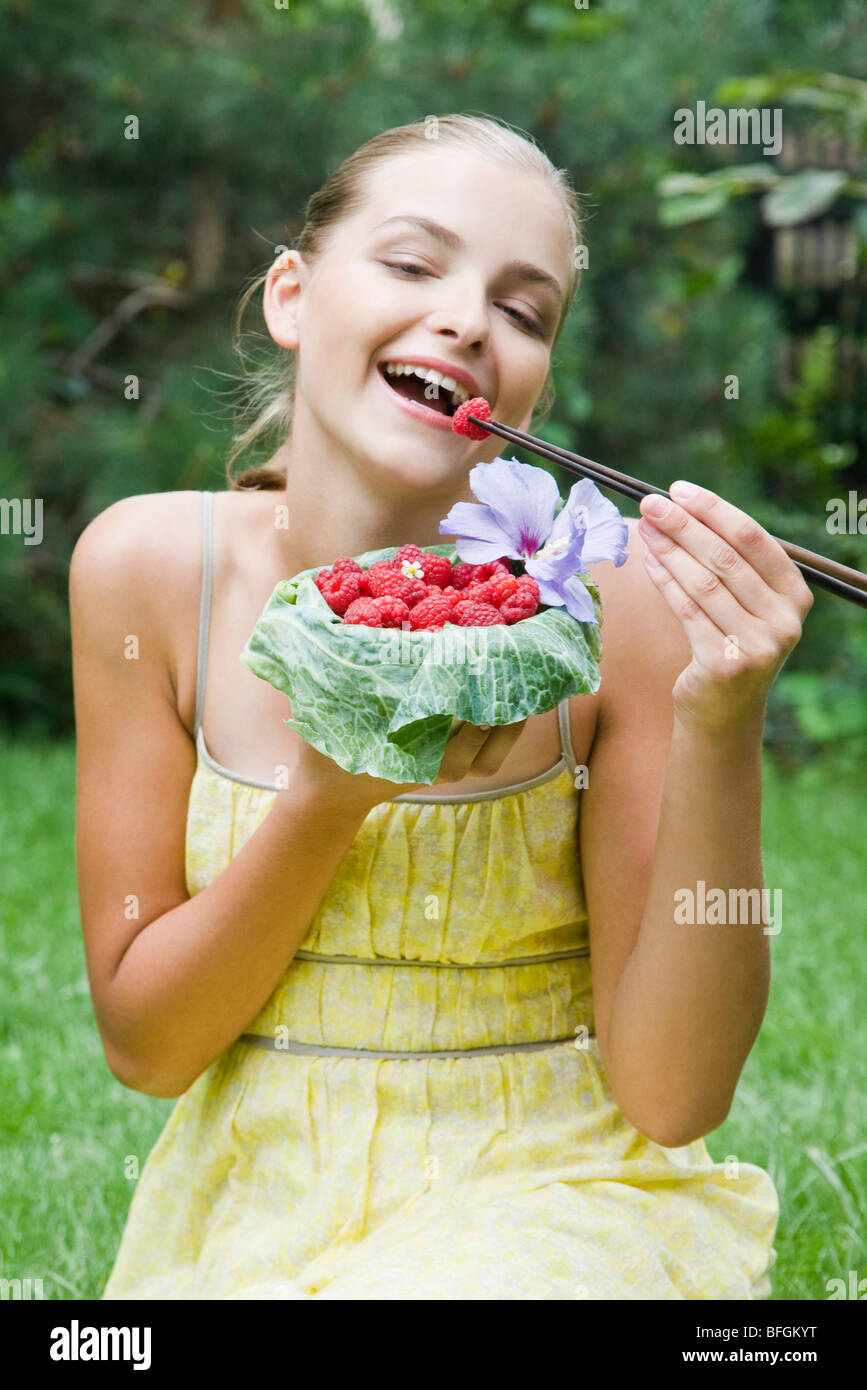 woman eating raspberries in garden Stock Photo - Alamy