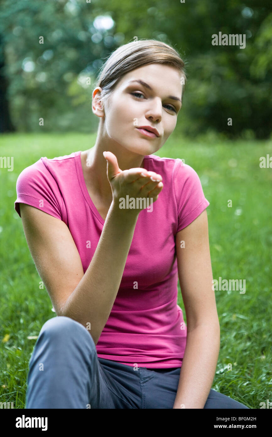 young woman sending a kiss Stock Photo - Alamy