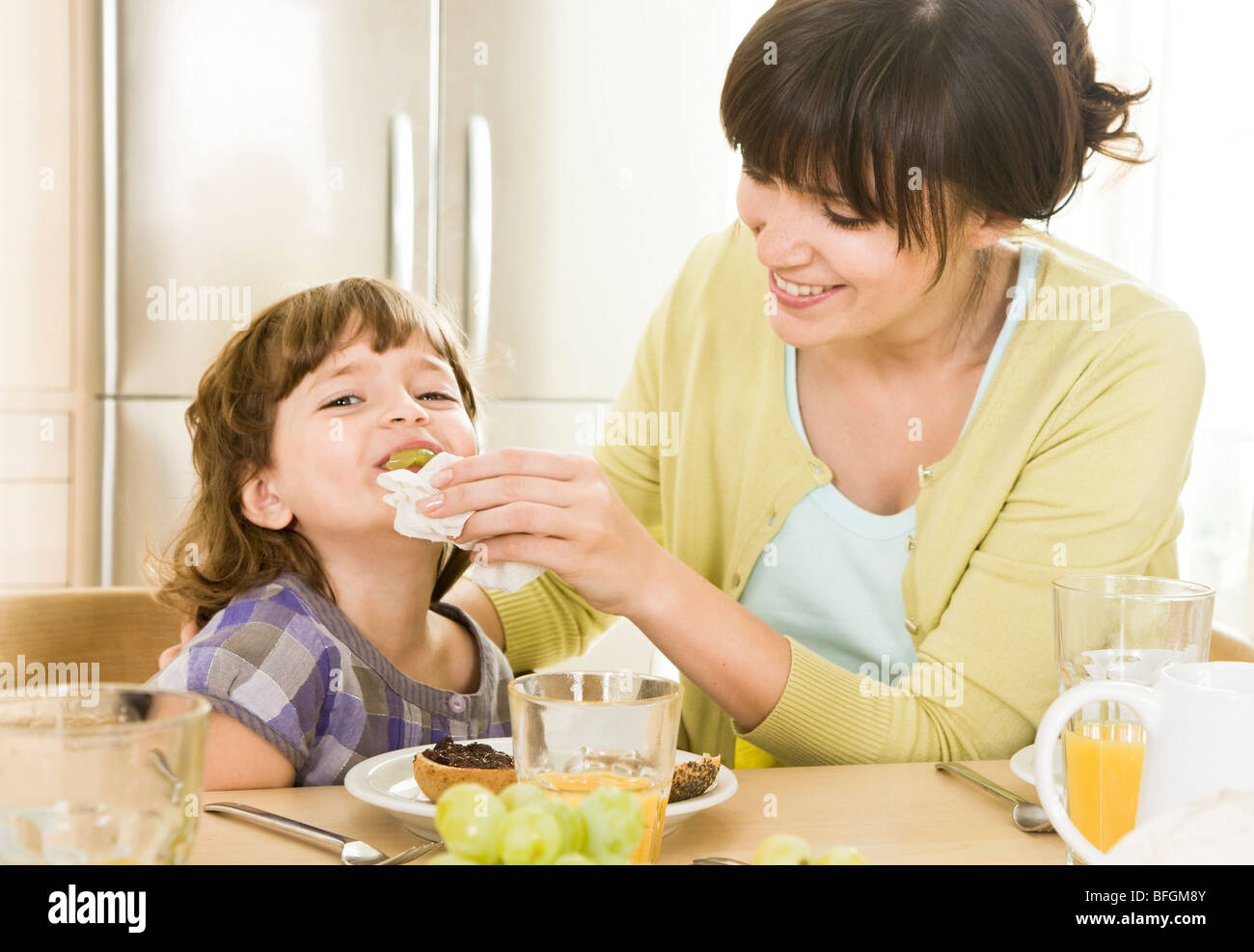 mother eating breakfast with daughter Stock Photo - Alamy