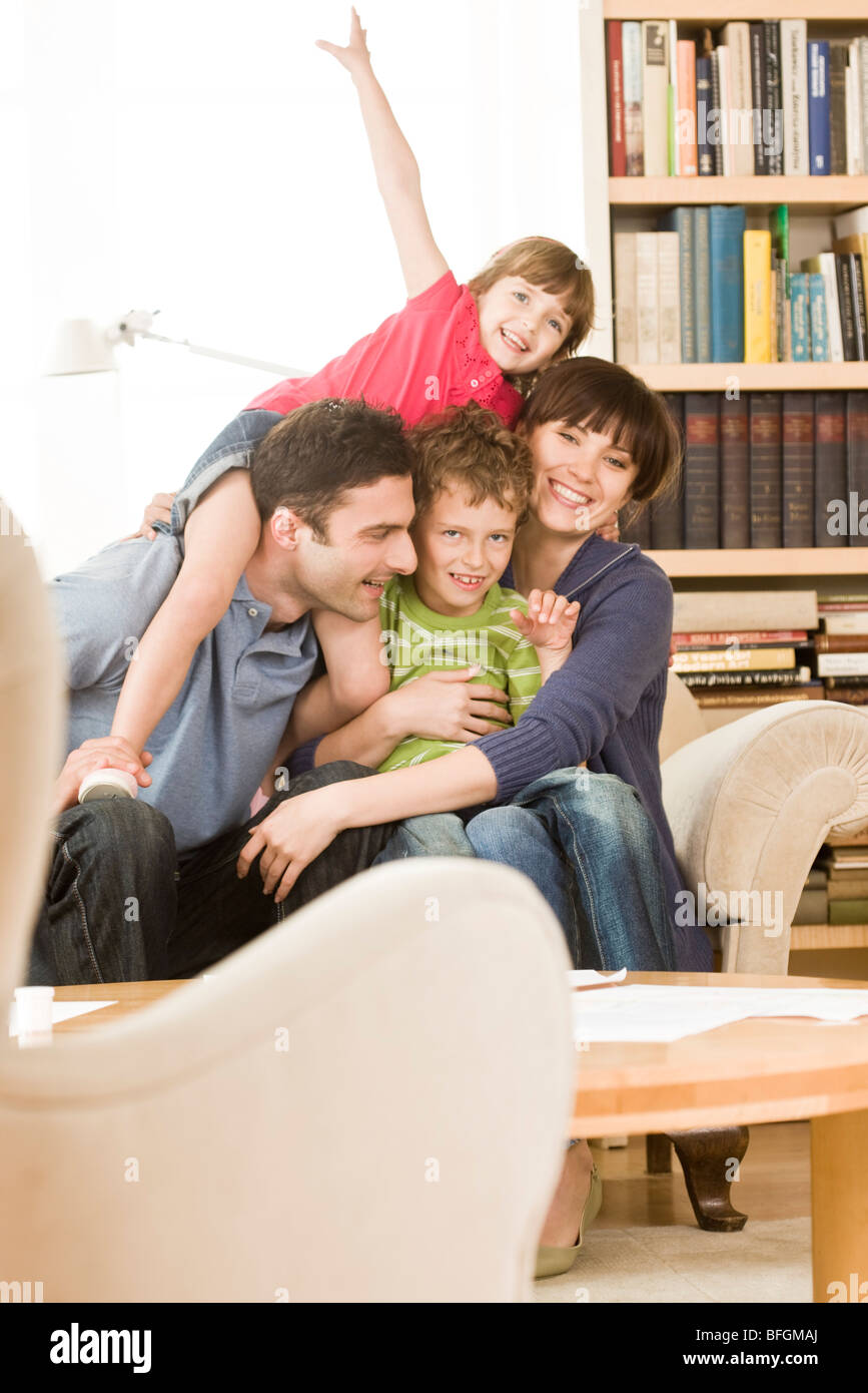 family sitting on sofa Stock Photo - Alamy