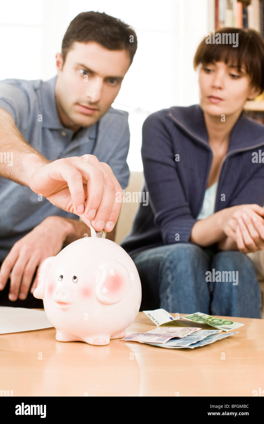 couple saving money Stock Photo - Alamy