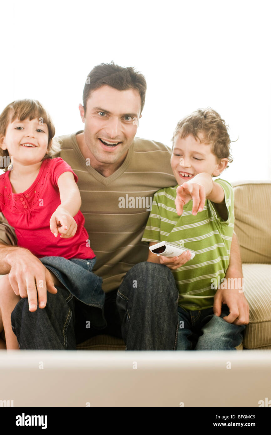 father watching tv with children Stock Photo - Alamy